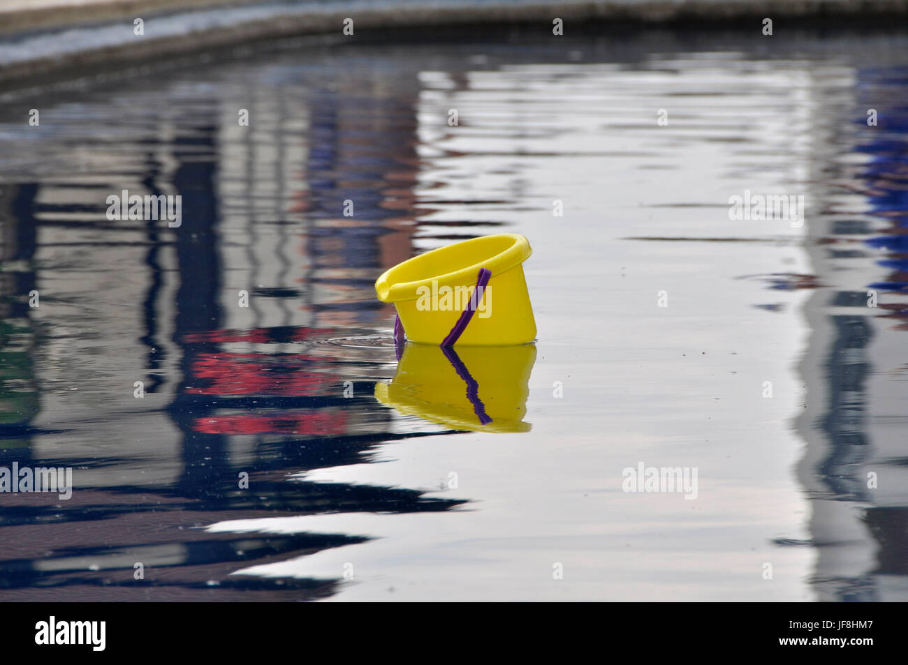 childs bucket floating in pond Stock Photo - Alamy
