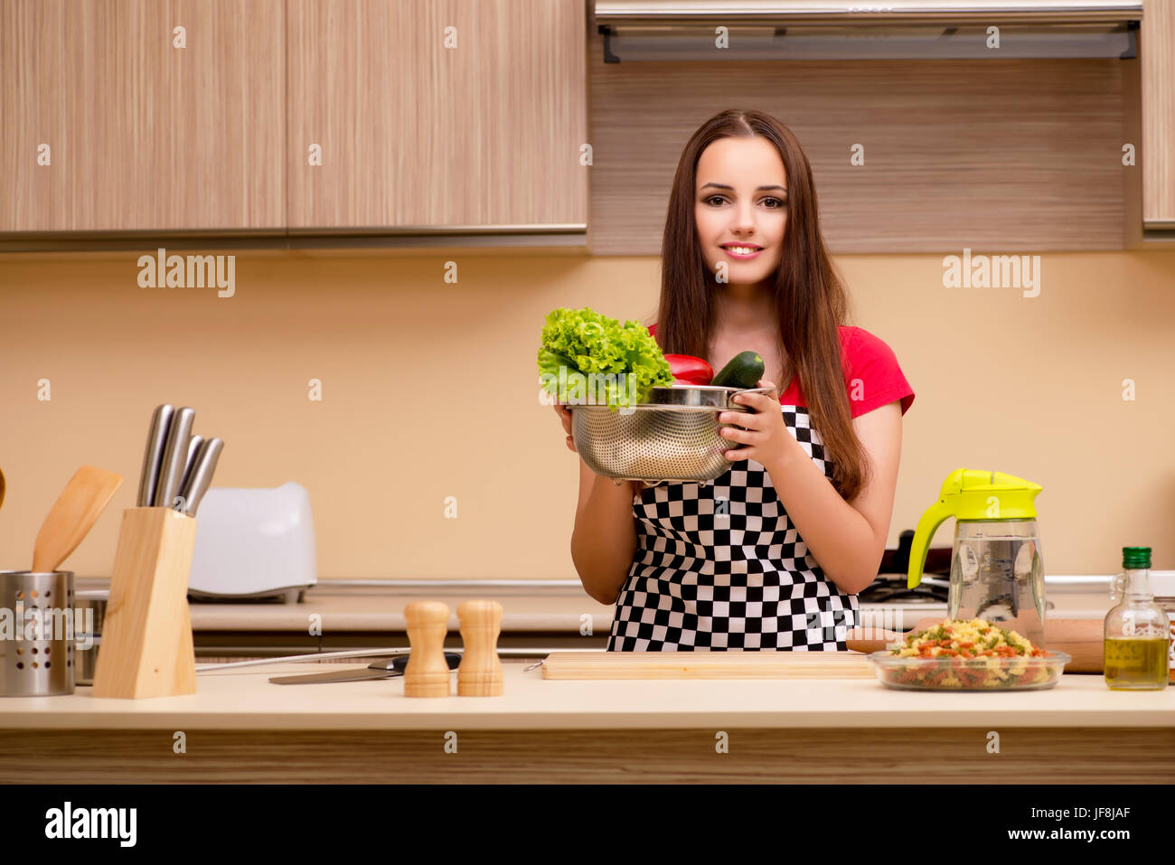 Young woman housewife working in the kitchen Stock Photo - Alamy