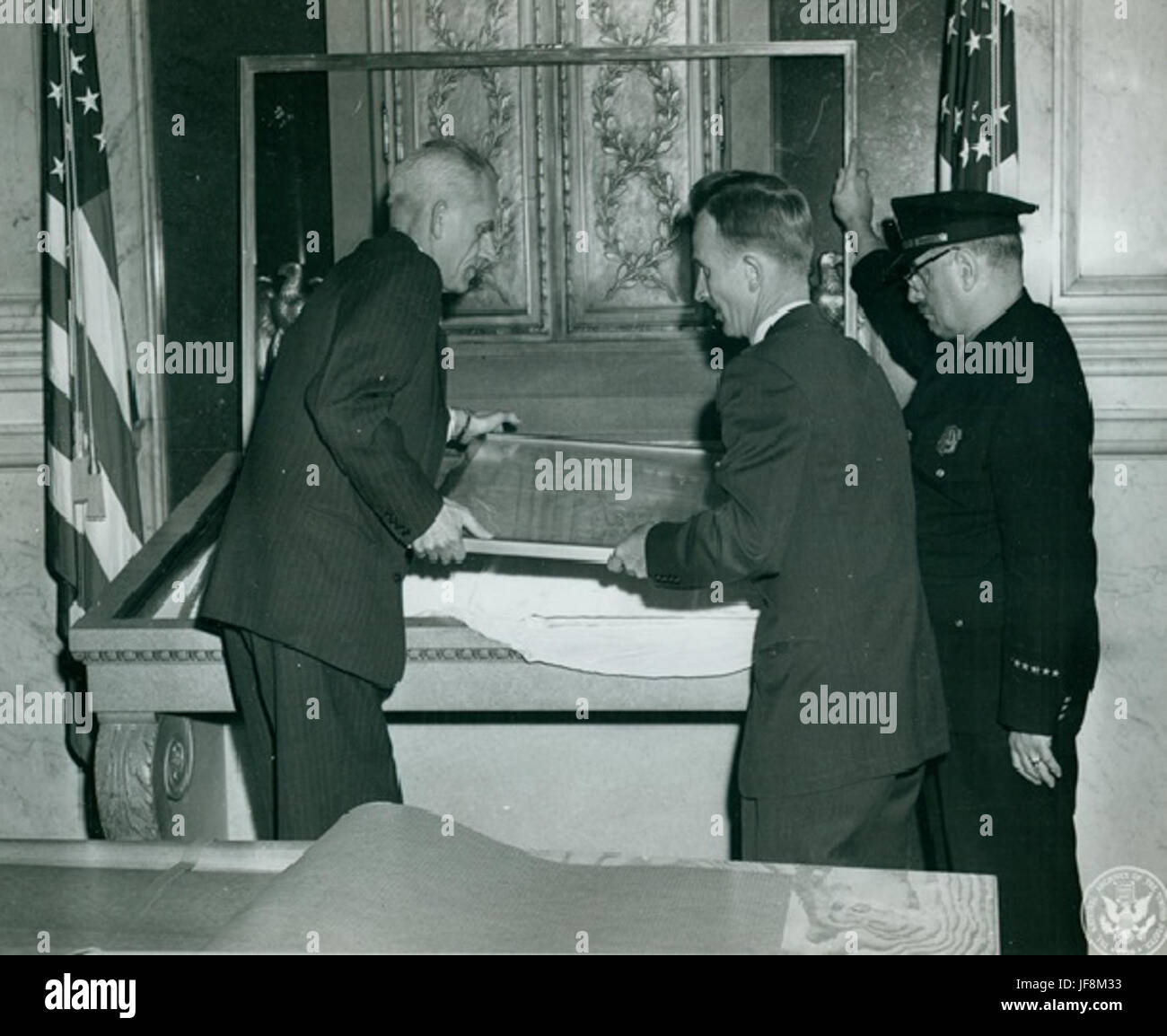 A dramatic photograph showing Library of Congress employees carefully ...