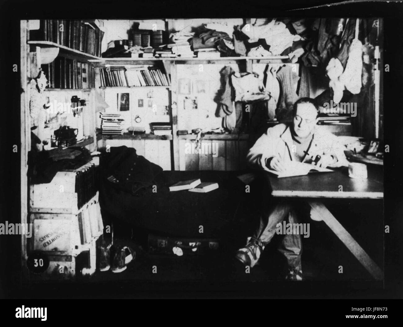 A historical image of Captain Robert Scott, writing in his journal ...