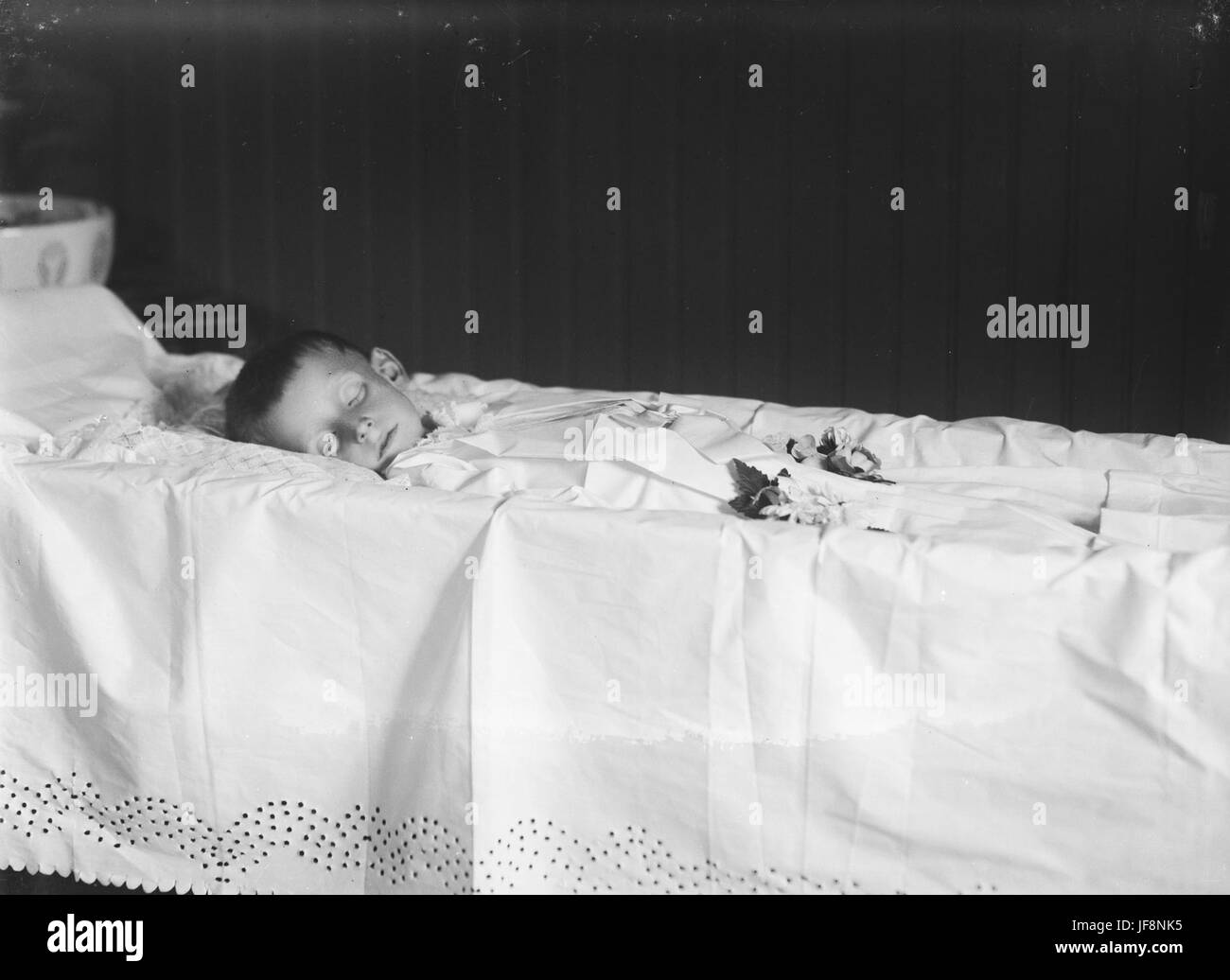 A haunting post mortem portrait from the early 20th century, featuring ...