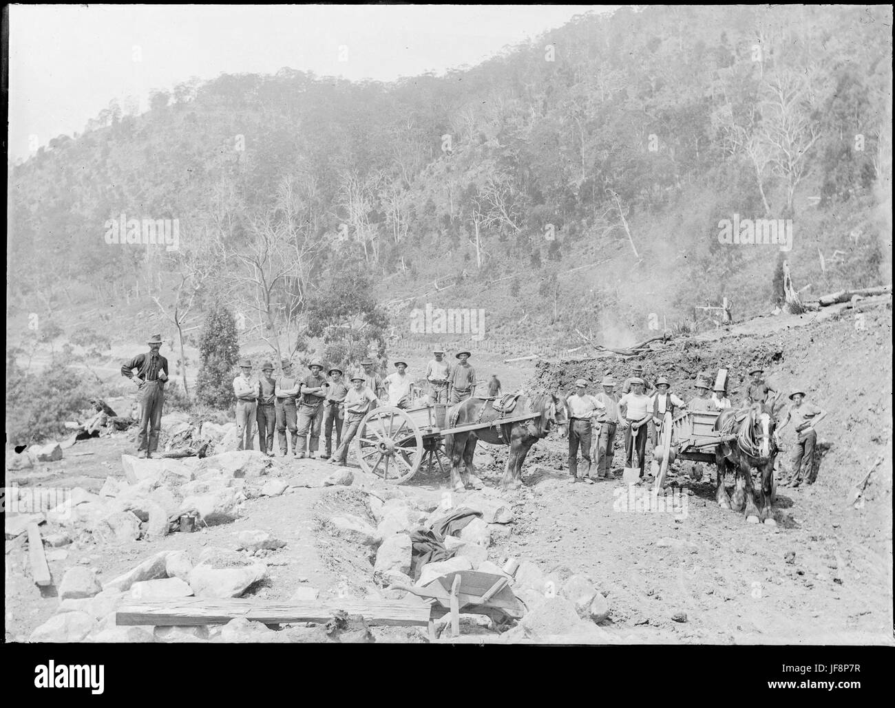 A historical photograph showing road construction laborers in Tasmania ...