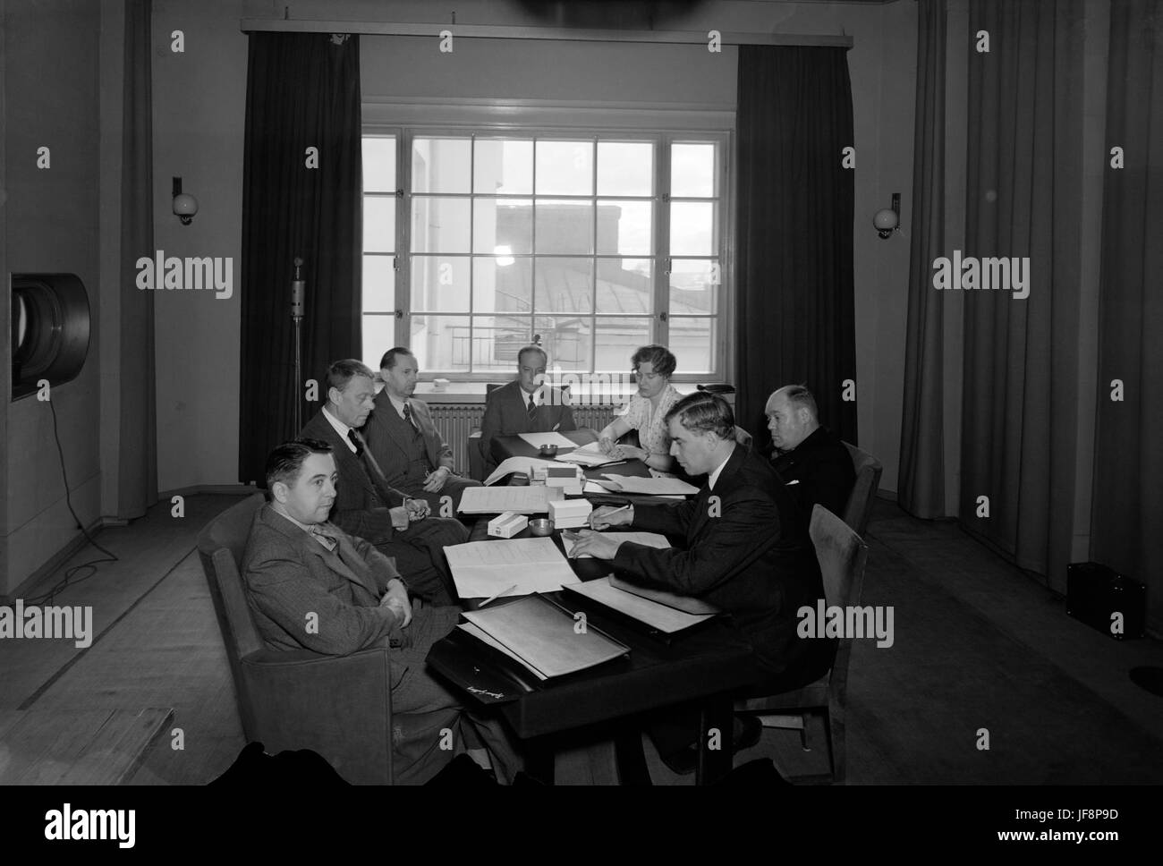 A behind-the-scenes photograph from a radio play rehearsal, capturing ...