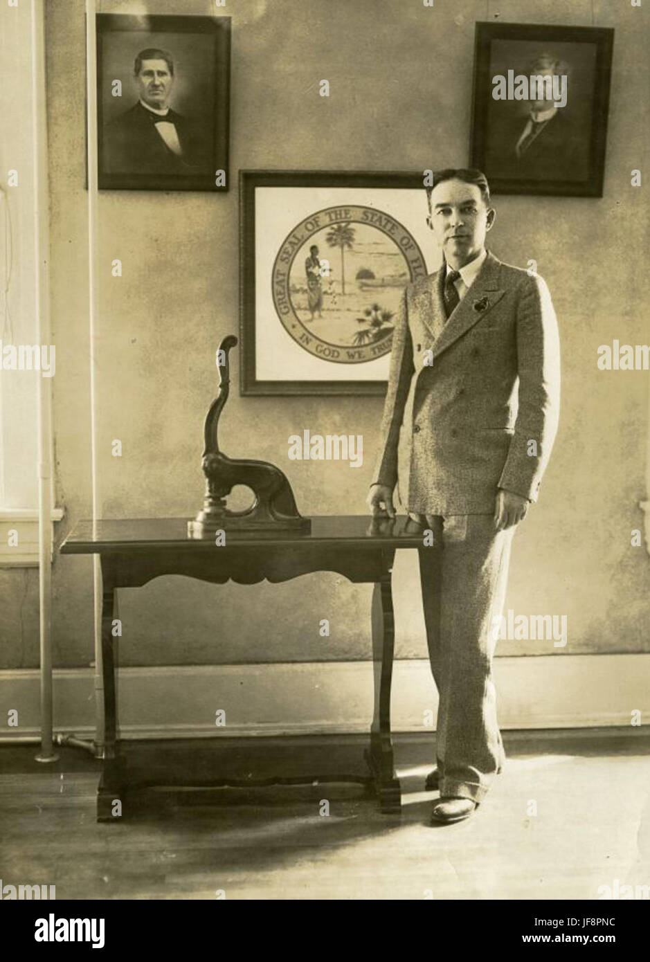 Secretary of State RA Gray is seen standing next to the seal embosser ...
