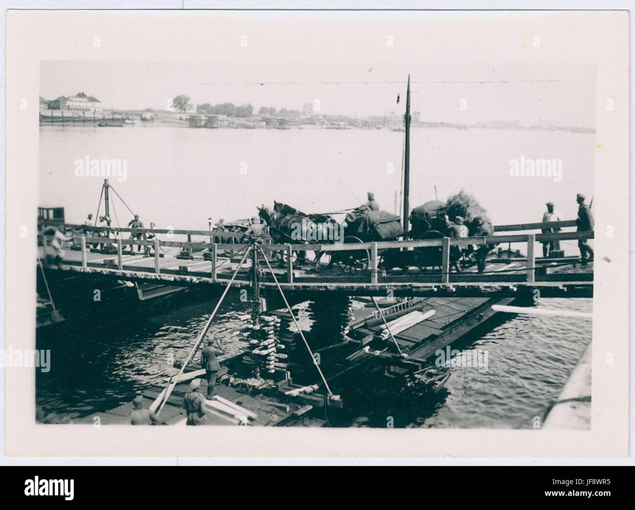 German soldiers crossing a river using a pontoon bridge during World ...