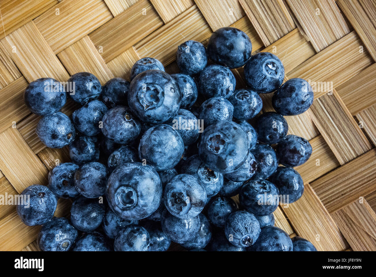 A pile of Blueberries seen on a woven Bamboo background Stock Photo - Alamy