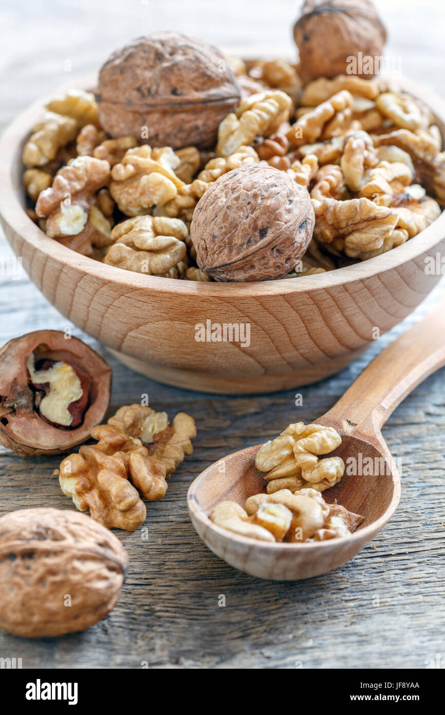 Bowl with walnuts and wooden spoon Stock Photo - Alamy