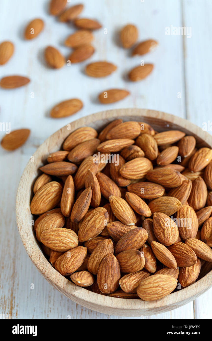 Almonds in a wooden bowl Stock Photo - Alamy