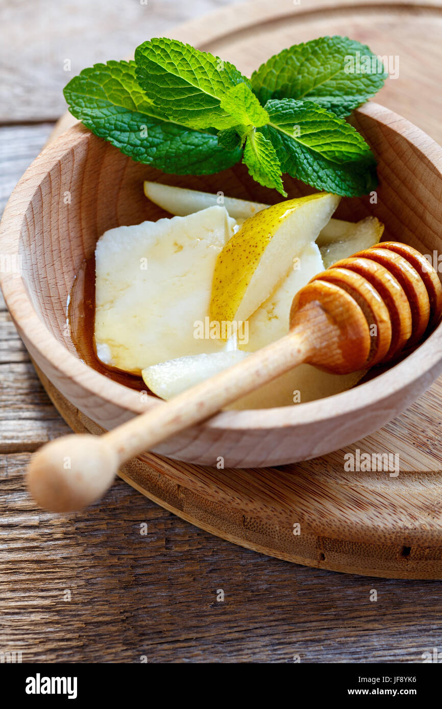 Soft cheese, pear, mint and honey Stock Photo - Alamy