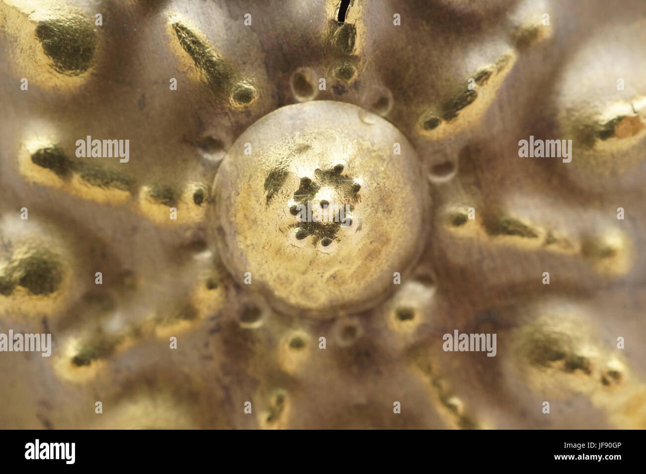 Beaten brass sun pattern, hand made object Stock Photo - Alamy