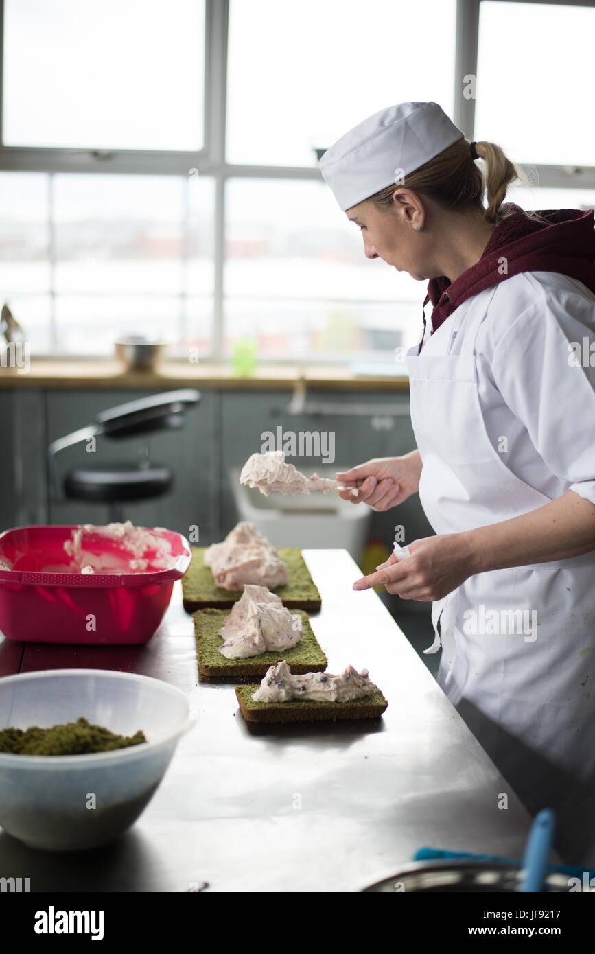 Woman chef making cake Stock Photo - Alamy