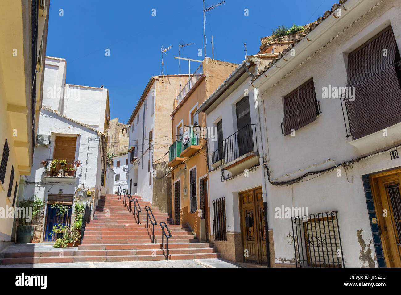 Colorful street and steps leading to he castle of Bunol, Spain Stock ...
