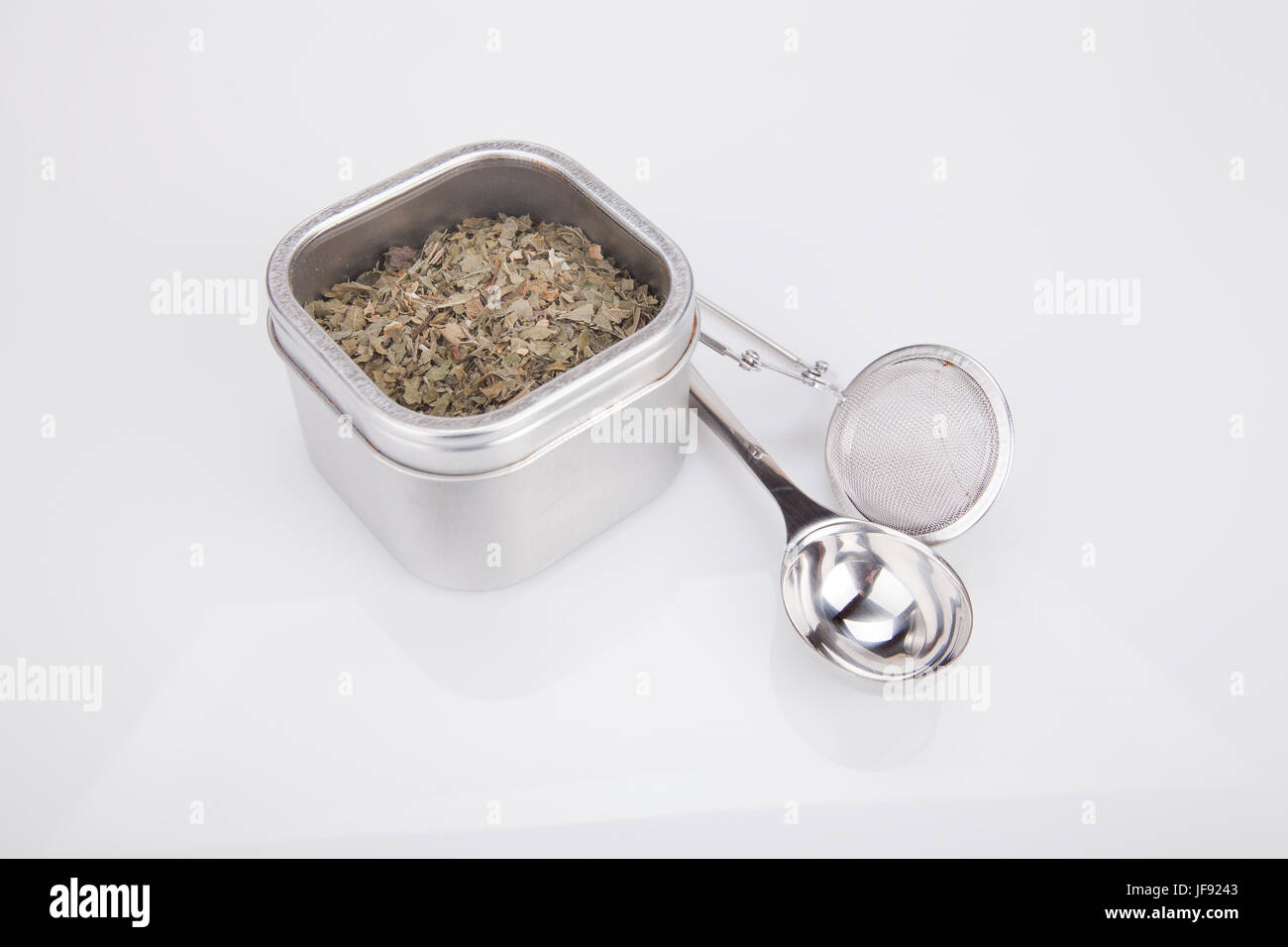 Tea leaves and accessories on a white surface. Tea kit isolated on ...