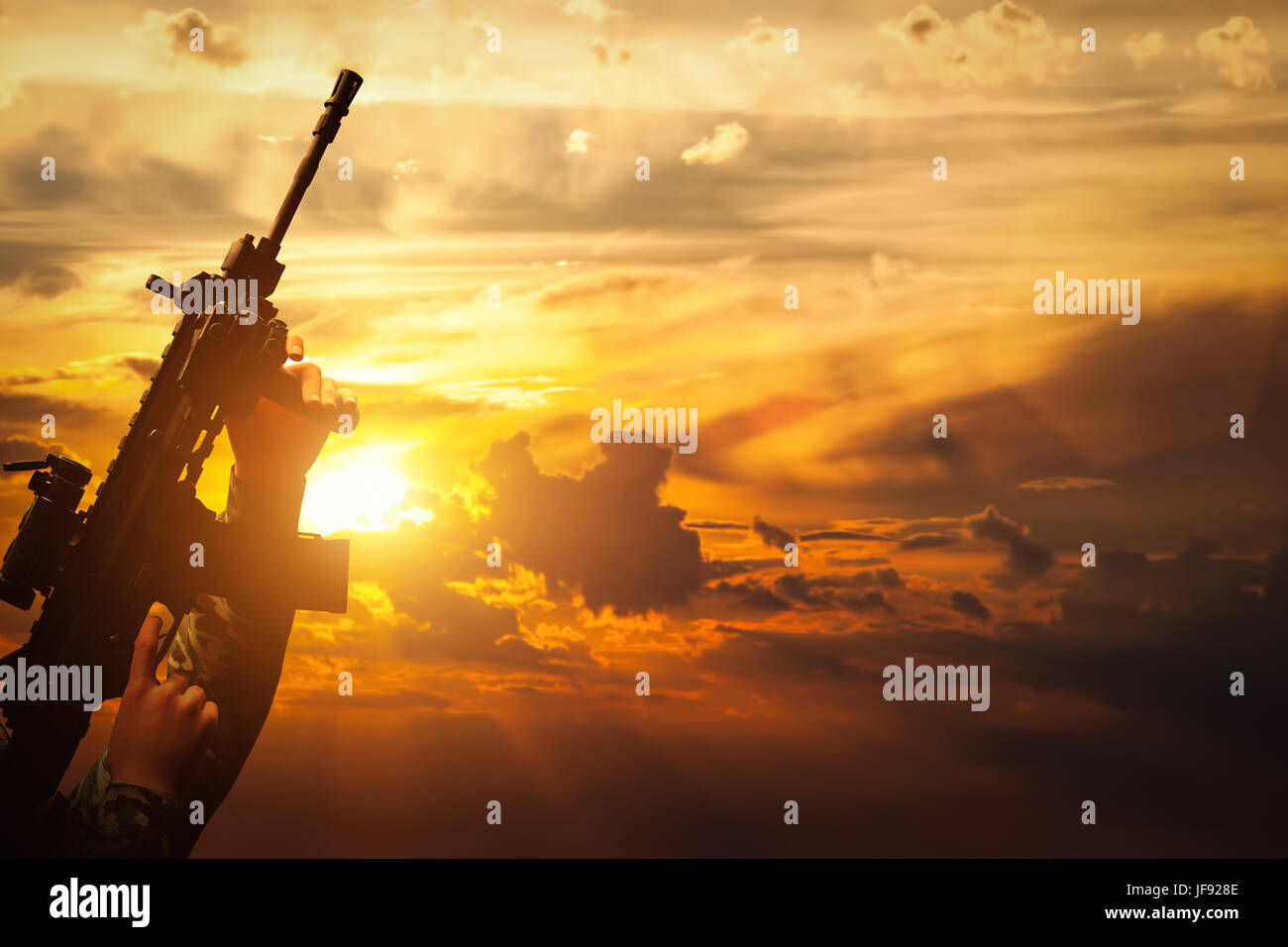 Soldier in combat shooting with his weapon, rifle at sunset. War, army ...