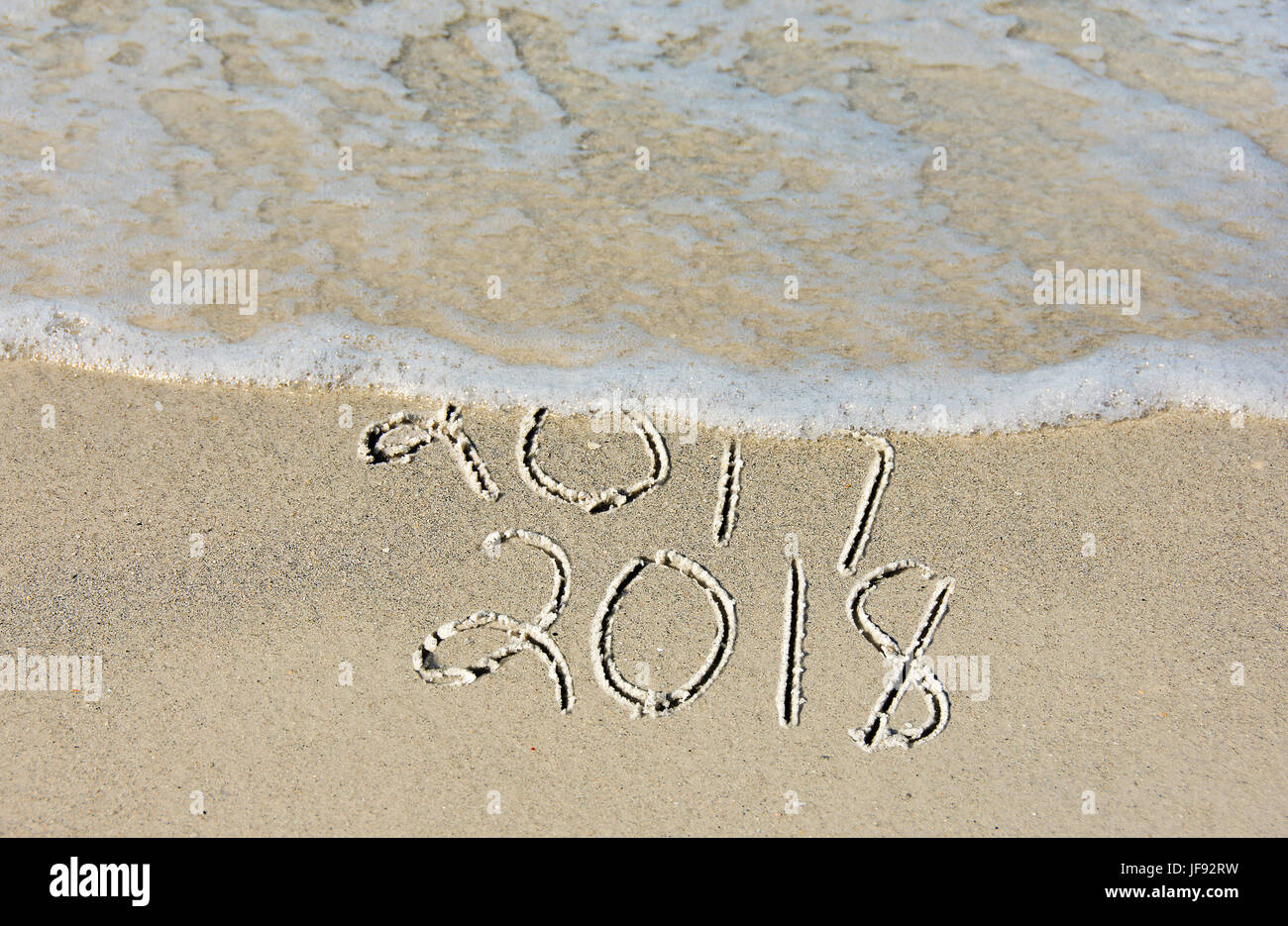 New Year 2018 in beach sand with frothy ocean surf Stock Photo - Alamy