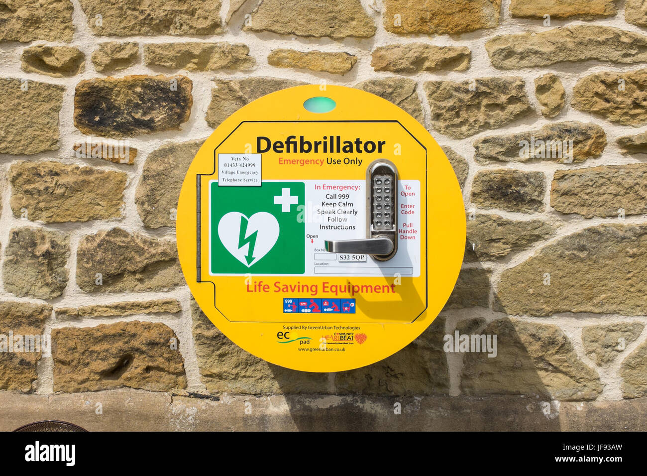 Wall-mounted defibrillator in the village of Eyam in the Derbyshire ...