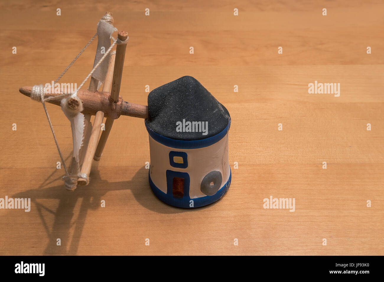 Miniature holland characteristic windmill isolated on wooden background ...