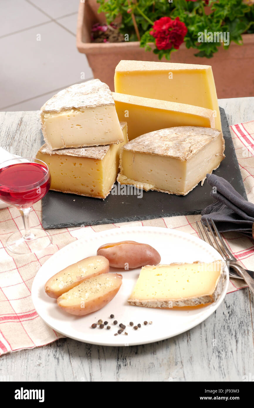 Different french cheeses with a glass of red wine Stock Photo - Alamy