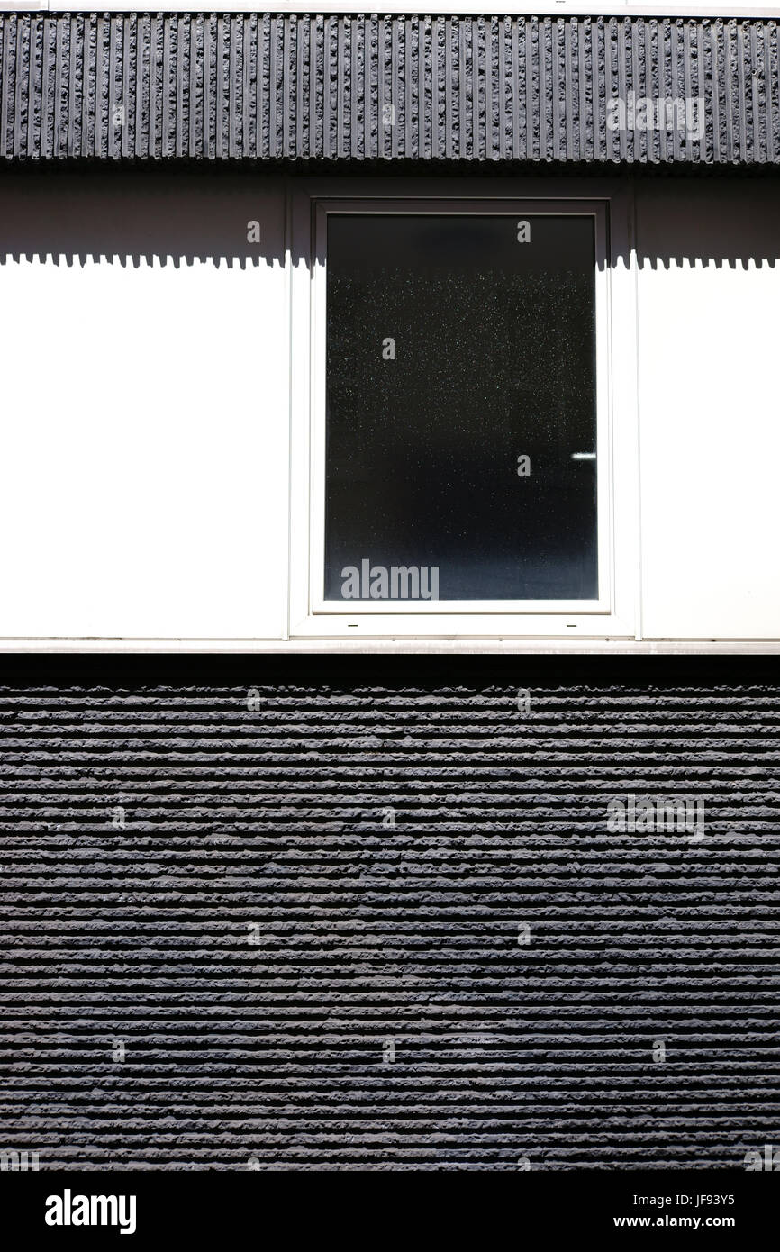 A gray clinker facade of rough stones on the facade of a building with ...