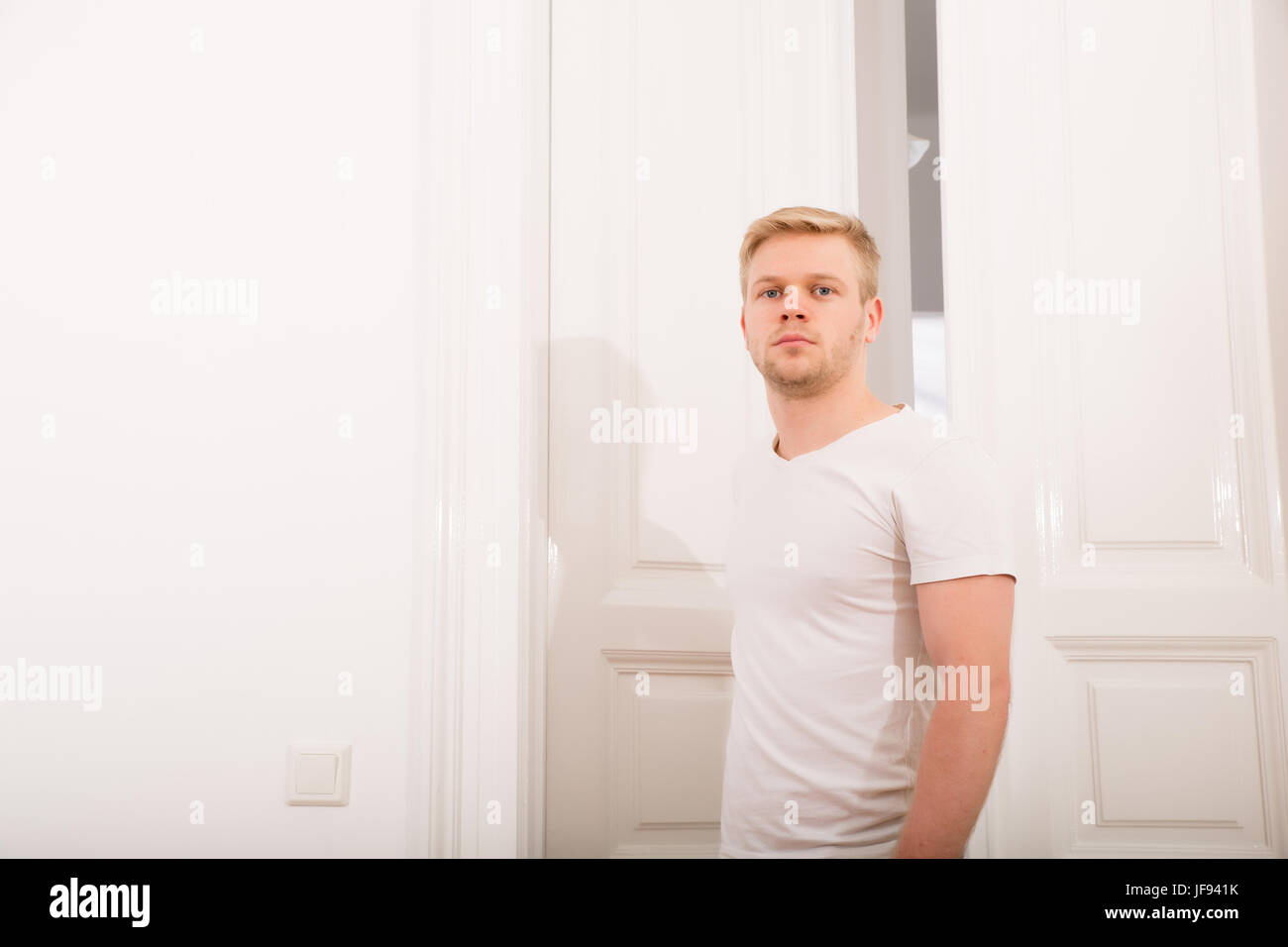 Young man coming home Stock Photo - Alamy