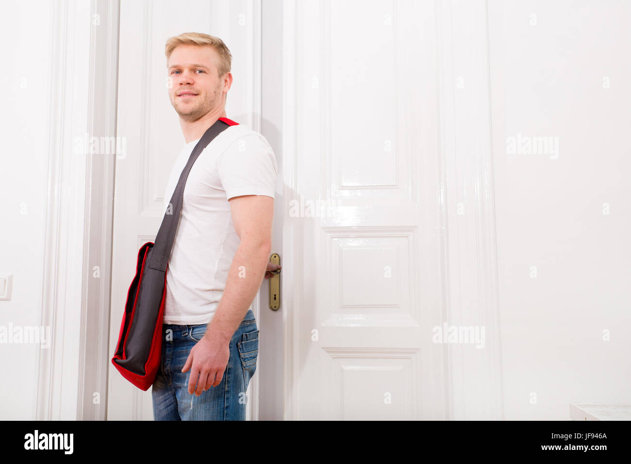 Young man coming home Stock Photo - Alamy