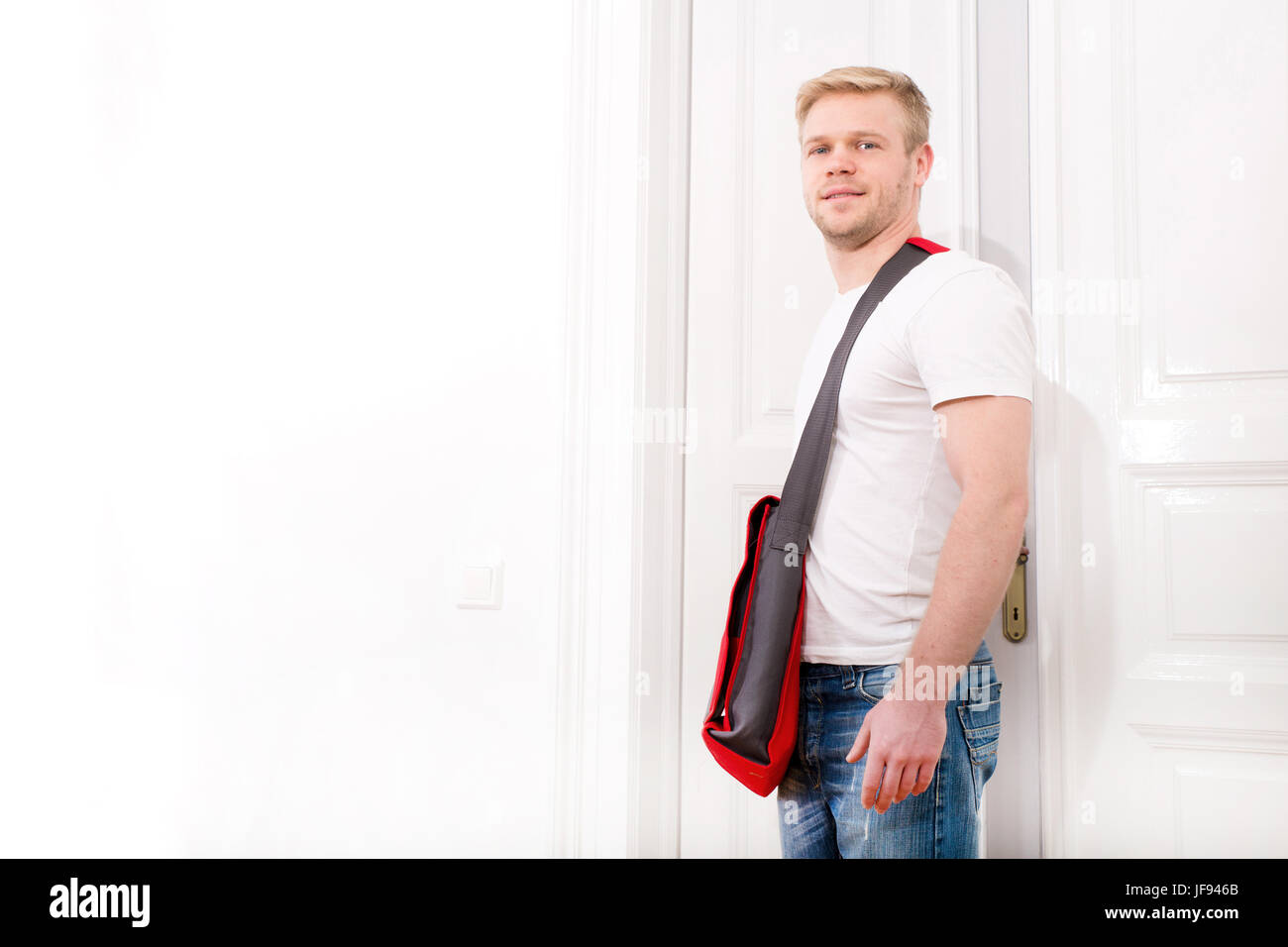 Young man coming home Stock Photo - Alamy