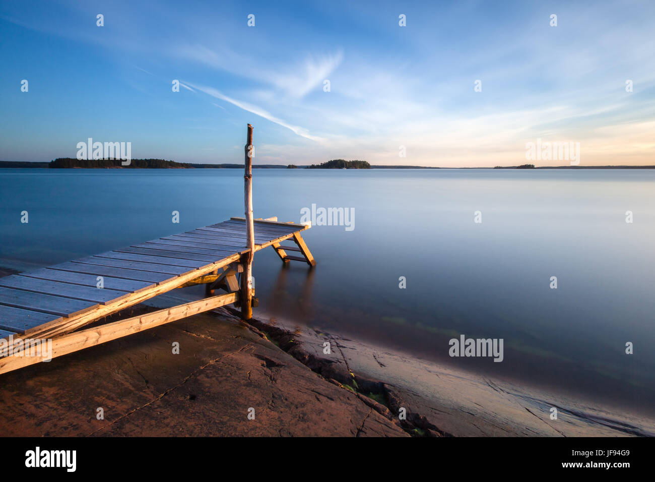 A wooden jetty on a rocky sea shore Stock Photo - Alamy