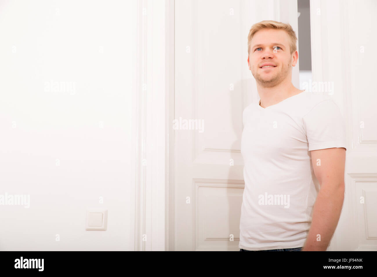 Young man coming home Stock Photo - Alamy