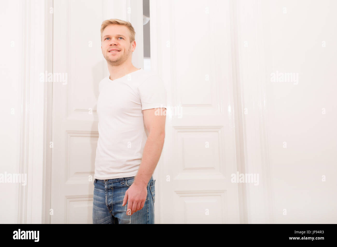 Young man coming home Stock Photo - Alamy