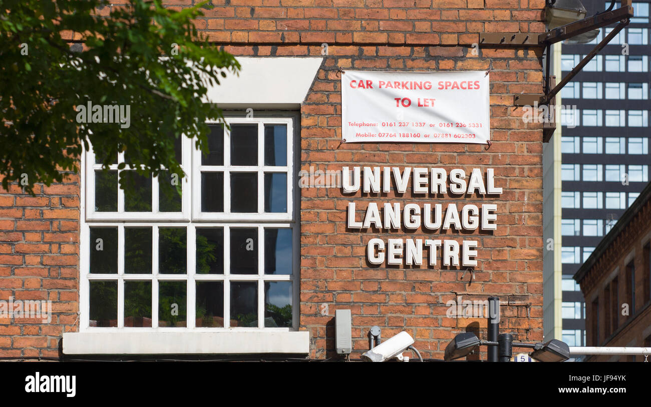 Wall-mounted advertising signage on brick building in central ...