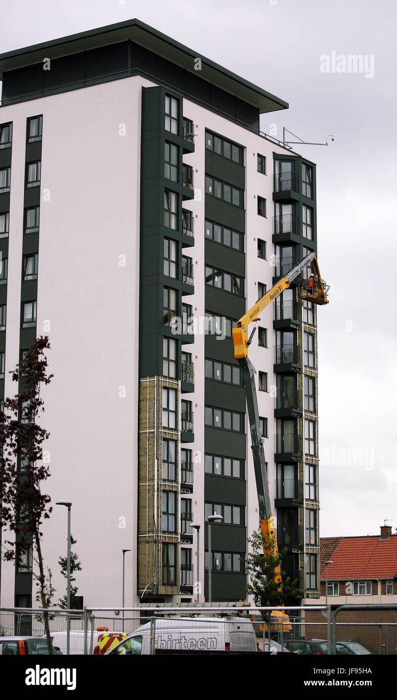 Workers on a cherry picker remove cladding panels from Kennedy Gardens ...