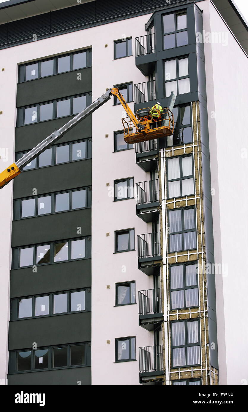 Workers on a cherry picker remove cladding panels from Kennedy Gardens ...