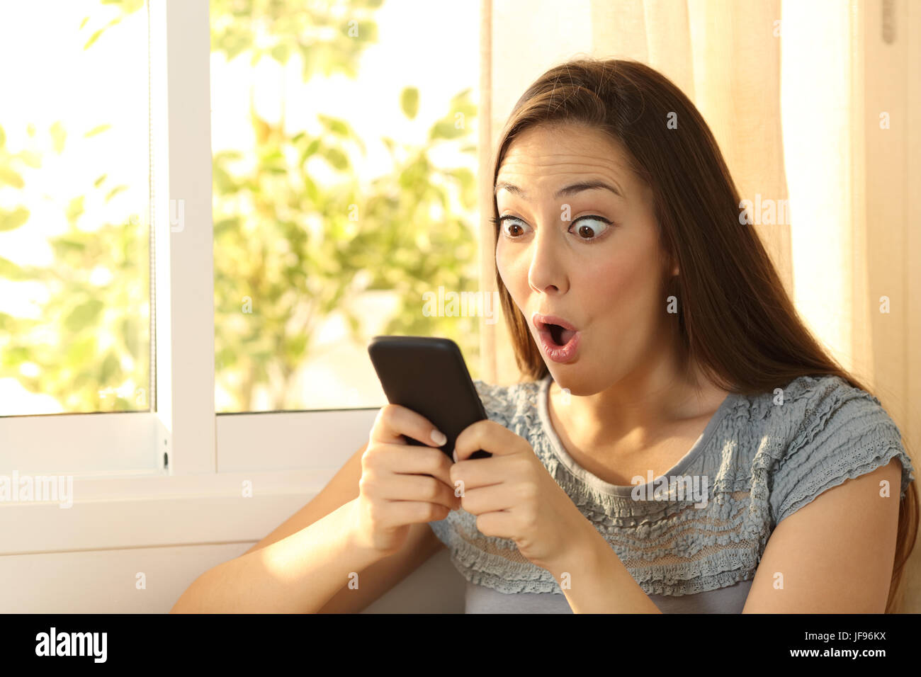 Young shock and surprise people watching the mobile phone hi-res stock ...