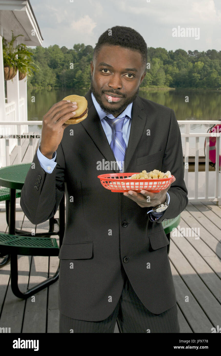 Man eating hamburger Stock Photo - Alamy