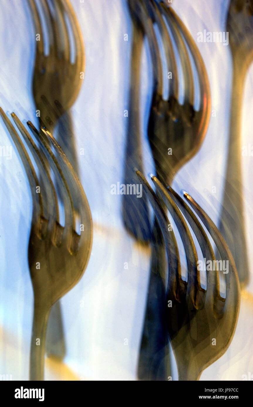 Photograph of a group of forks standing in the studio with strobe and ...