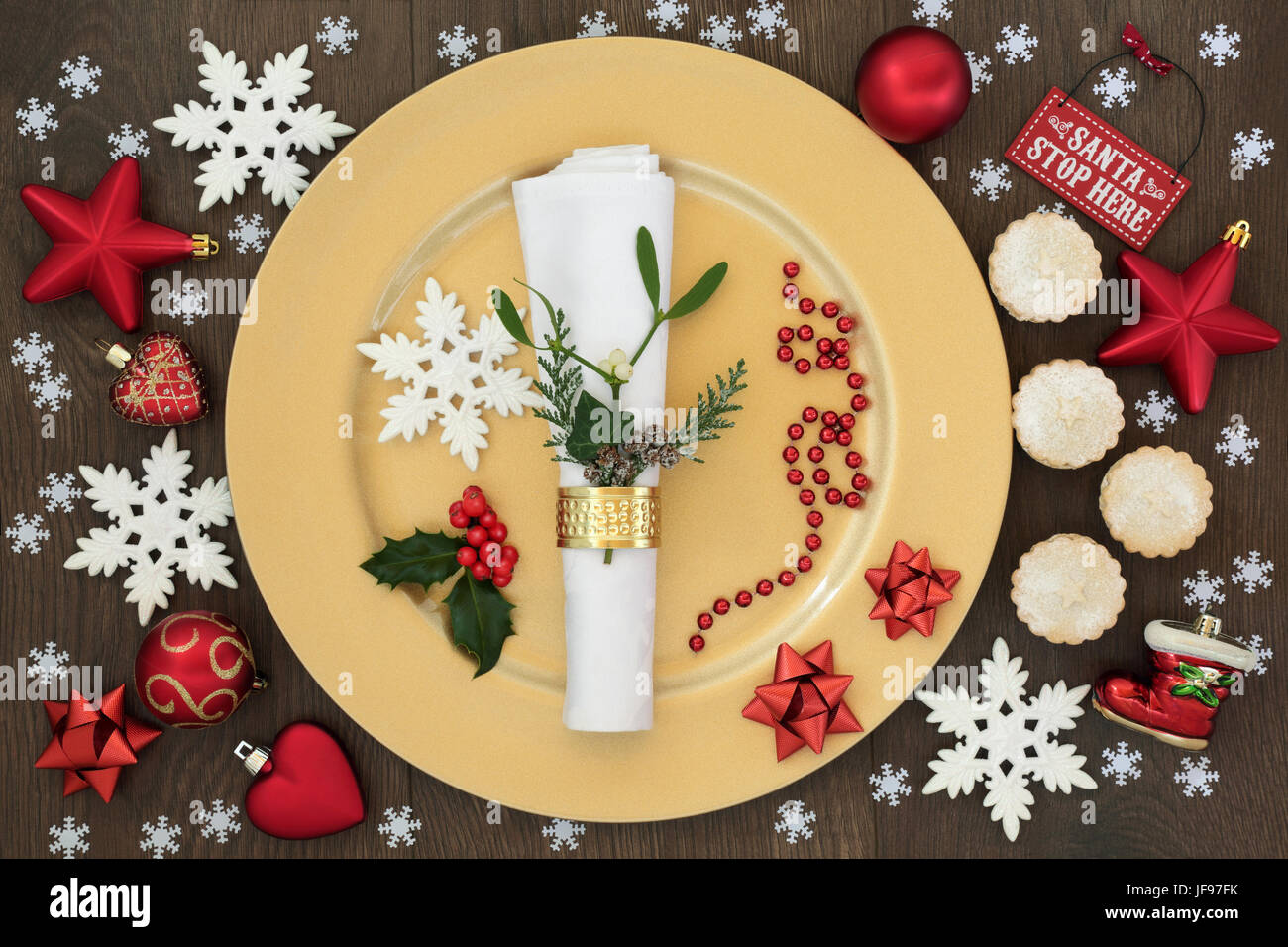 Christmas dinner place setting with gold plate, napkin and ring with ...