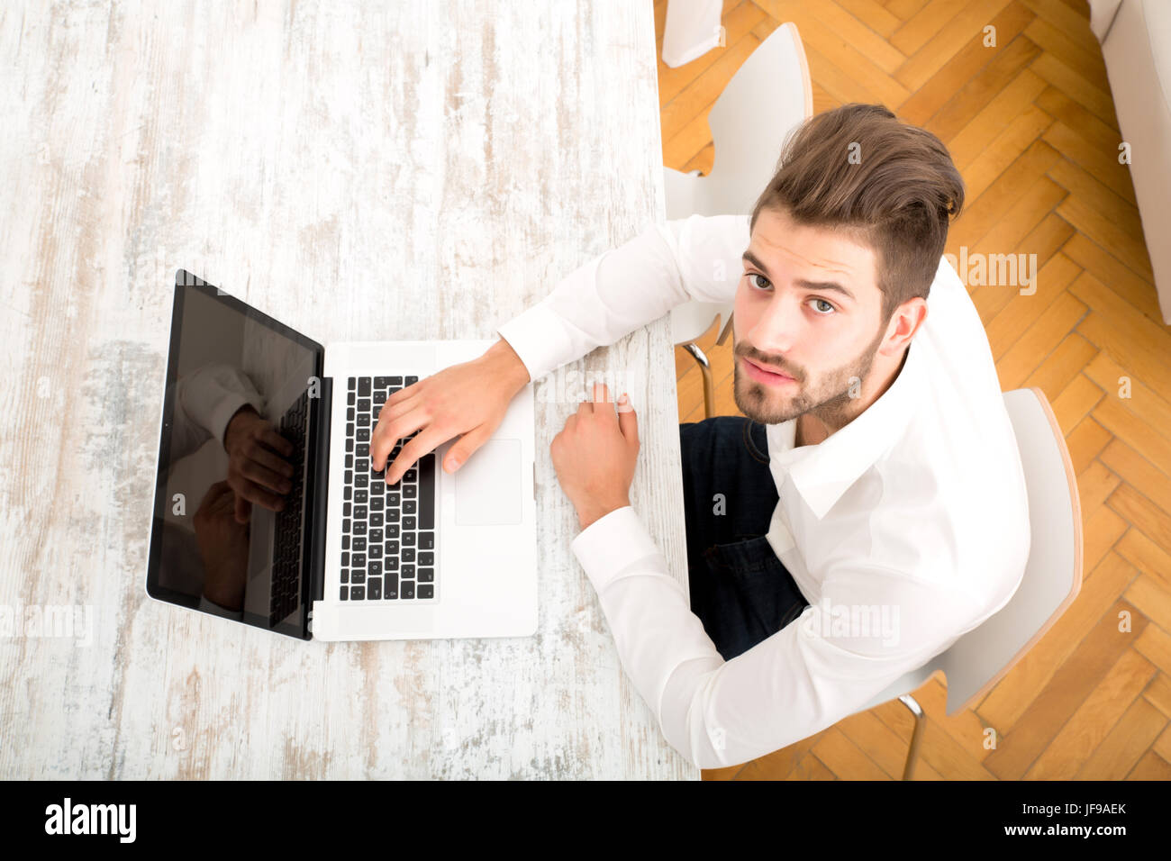 Young man with a laptop computer Stock Photo - Alamy