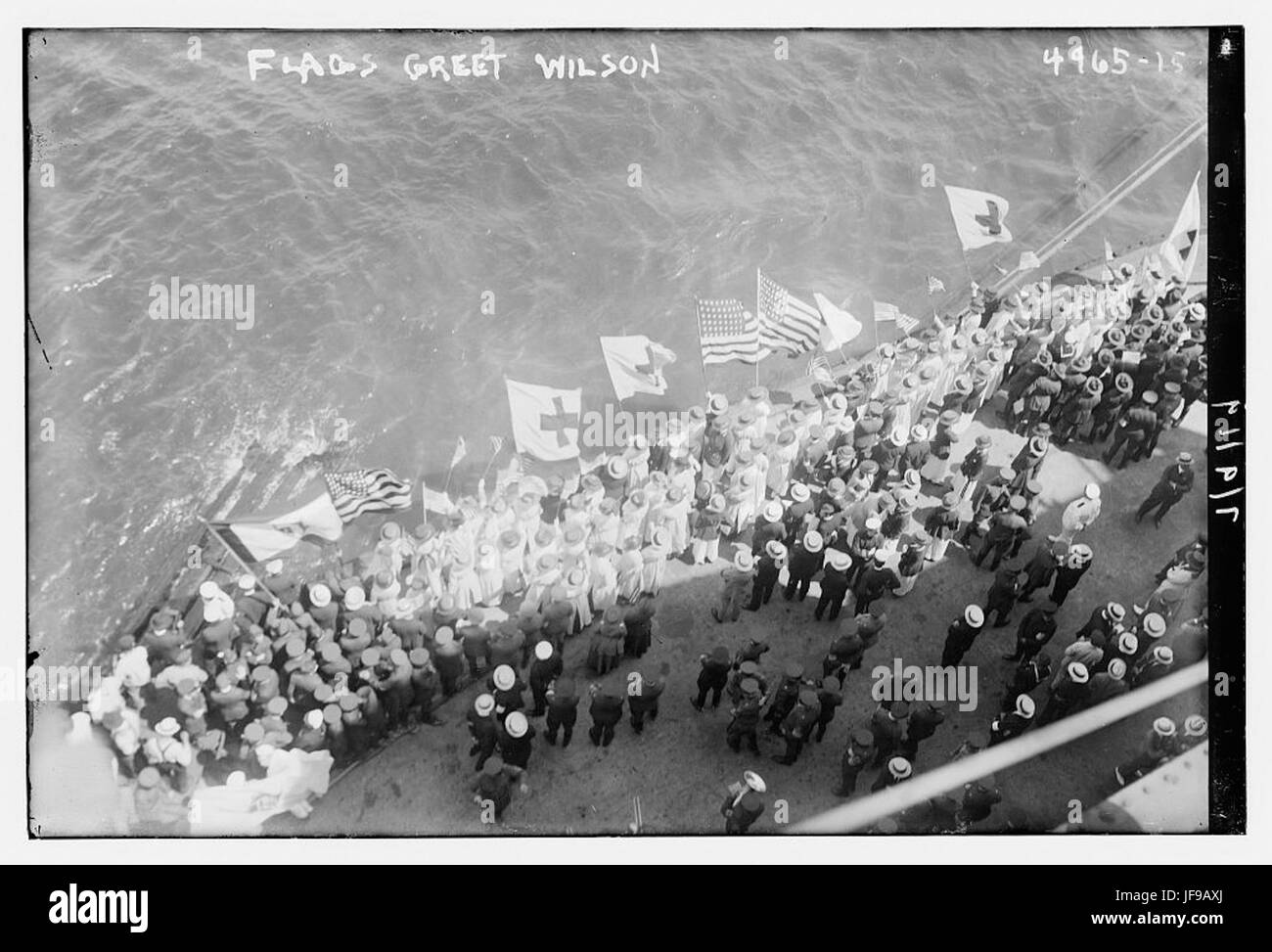 A historical photograph capturing the moment flags were raised to greet ...