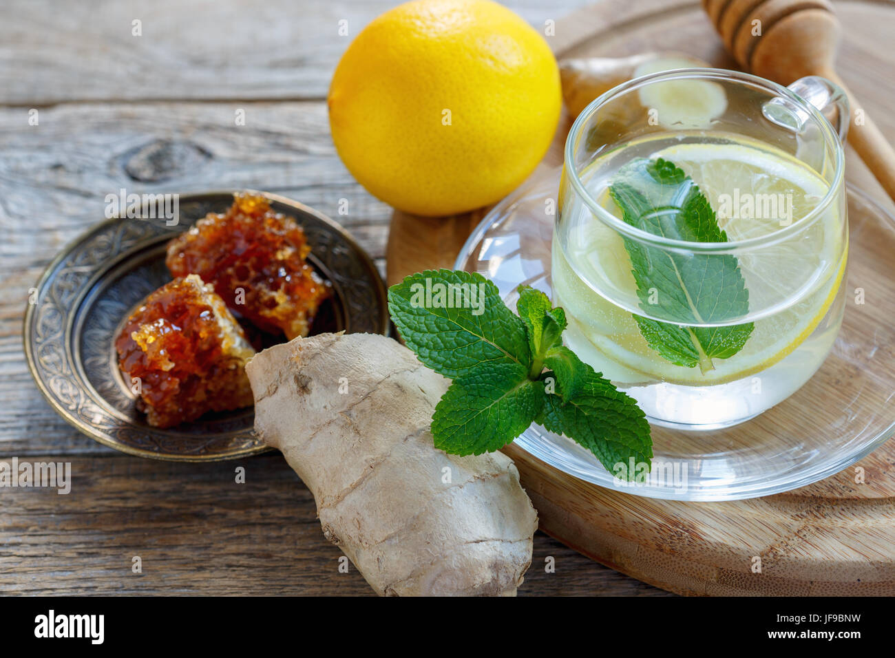 Healing drink with ginger, lemon, mint and honey Stock Photo - Alamy