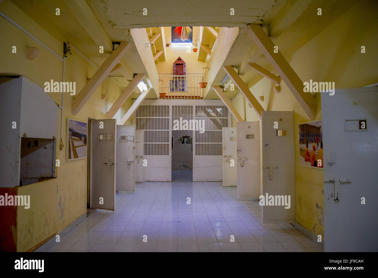 Indoor view of old deserted rugged building, cells of prisoners with ...