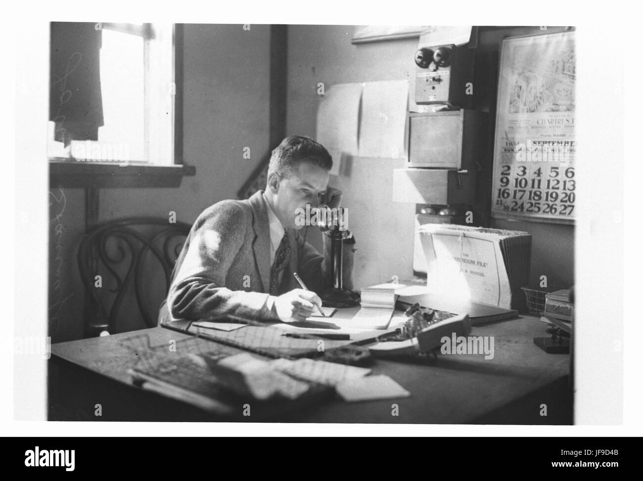 John Strange answering the phone in his office, vintage photo Stock ...