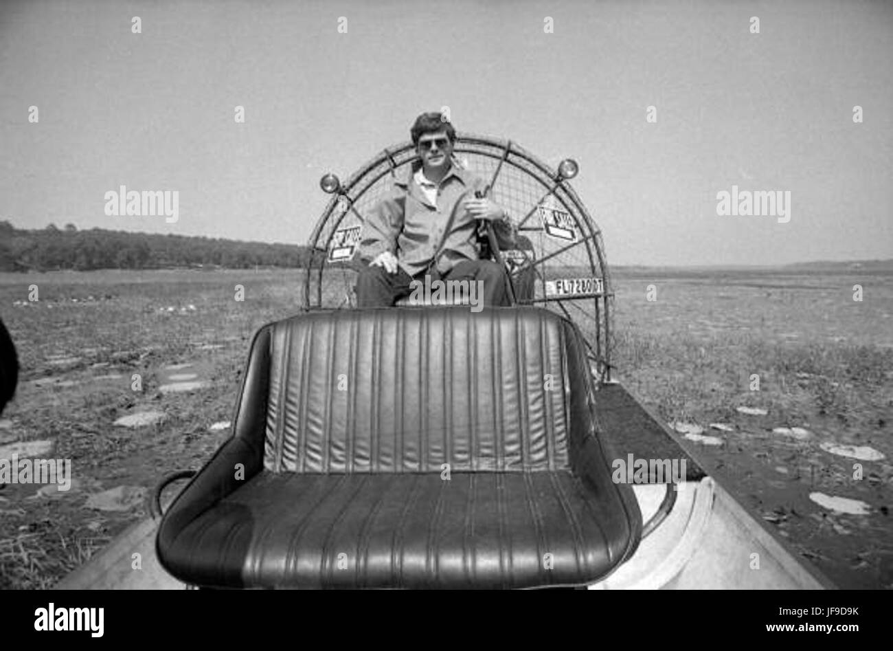 A man navigating an airboat through the waters of Tallahassee, Florida ...