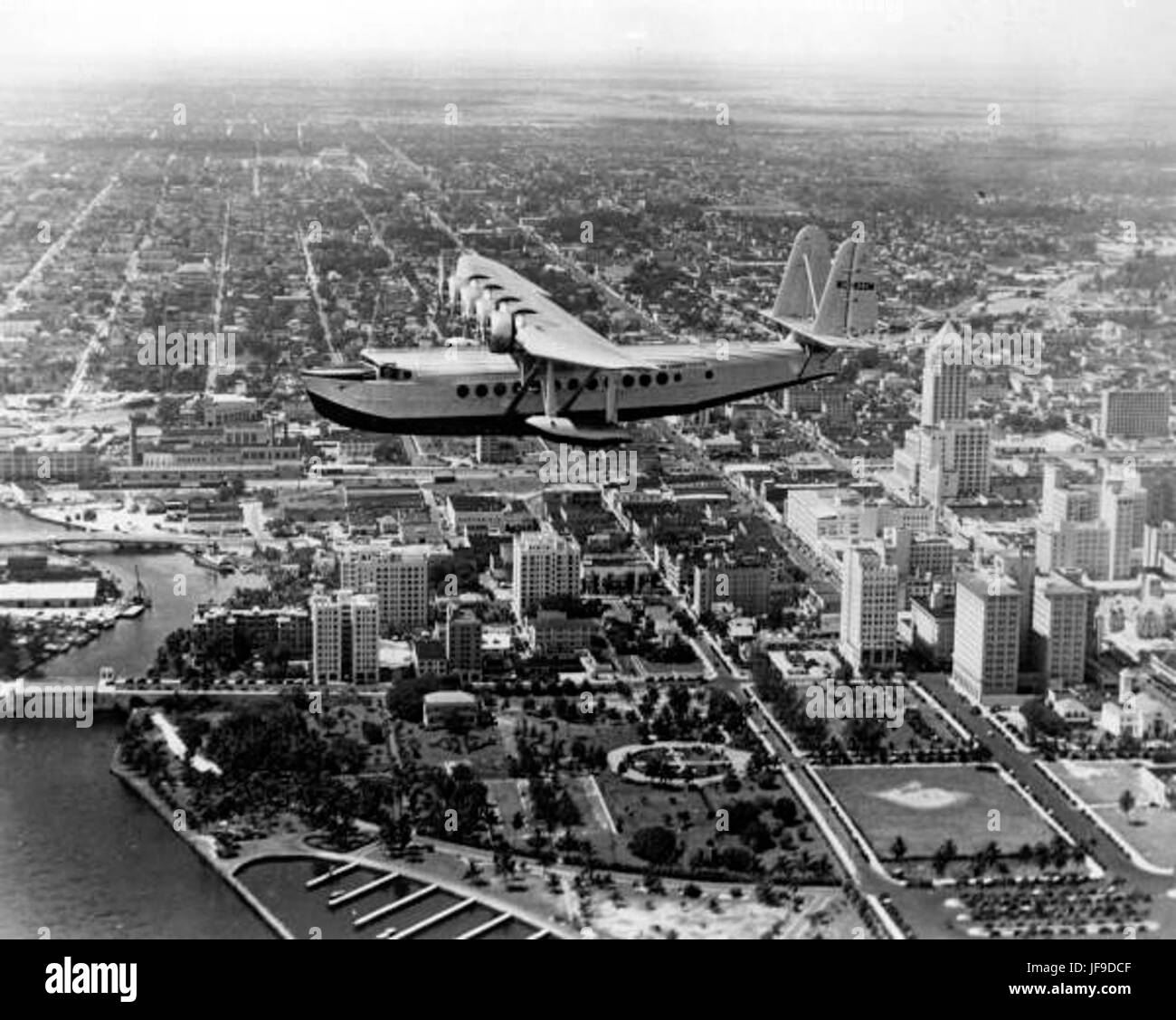A historic aerial photograph of the Sikorsky S-42 plane flying over ...