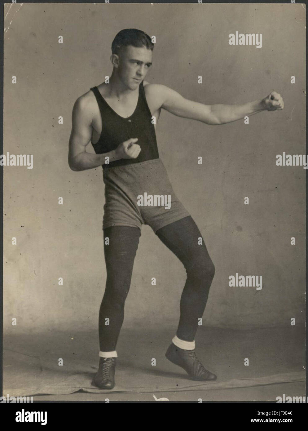 A dramatic portrait of boxer Bobby Delany captured in a boxing pose ...