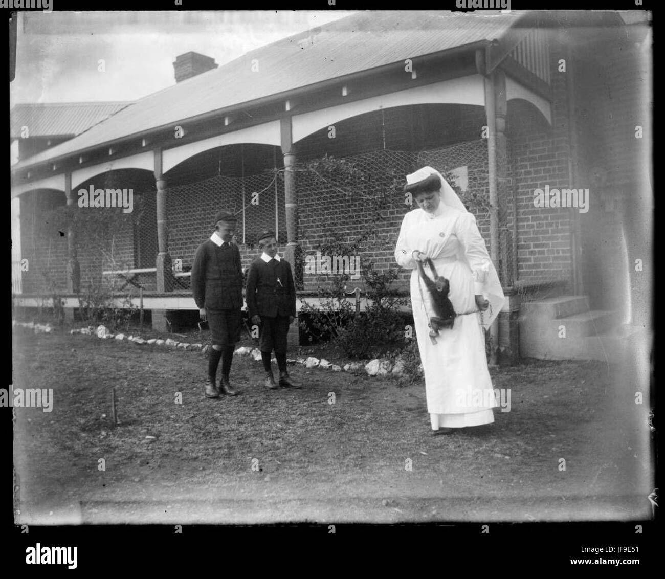 Matron Young poses with Dr. Gabriel's pet monkey, a quirky moment from ...