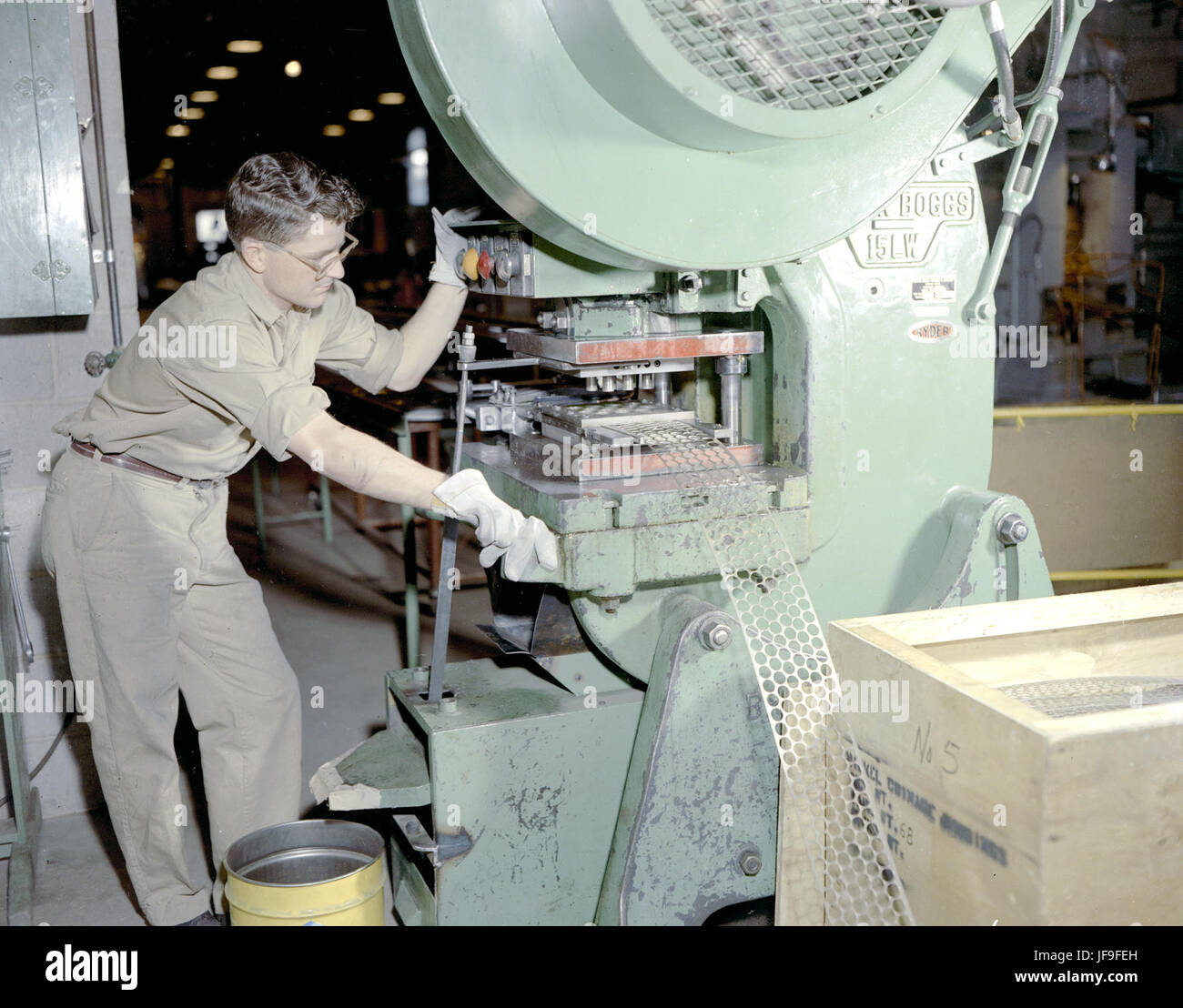 A machinist working at the Sherritt Gordon Mint in Calgary, Alberta ...