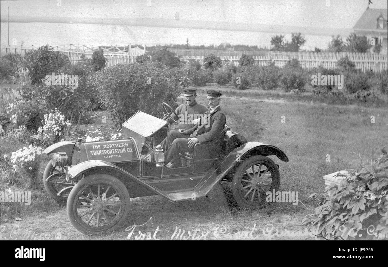 A historic moment showing the first car in Grouard, Alberta, marking ...