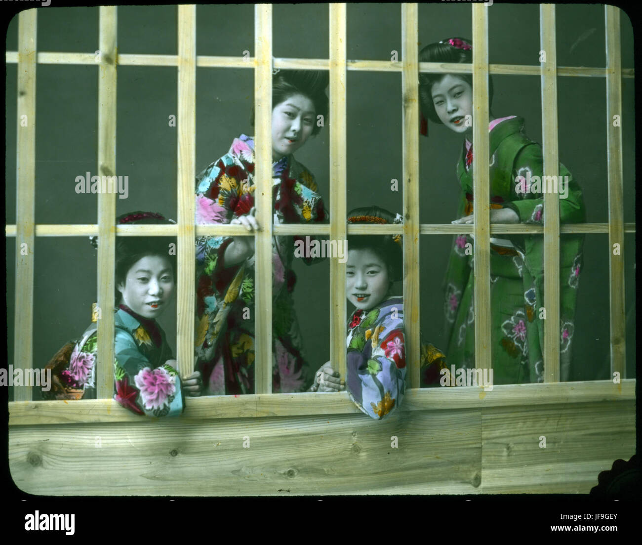 Women in traditional Meiji-era Japan smiling through lattice windows ...