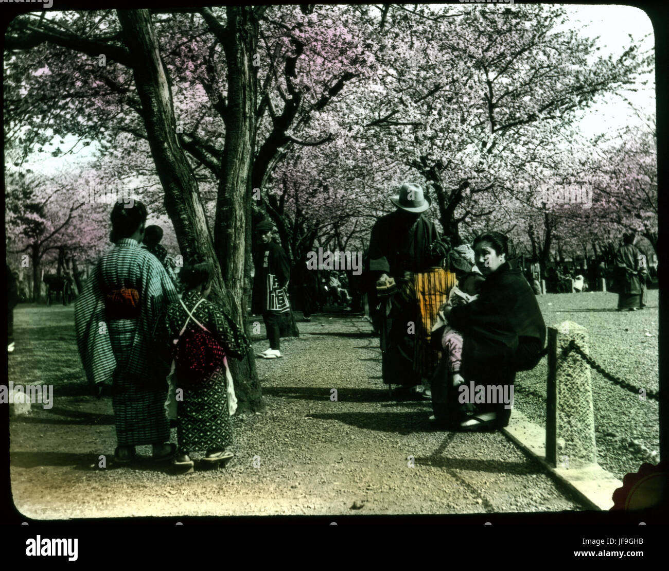 A photograph showing people dressed in traditional attire walking ...