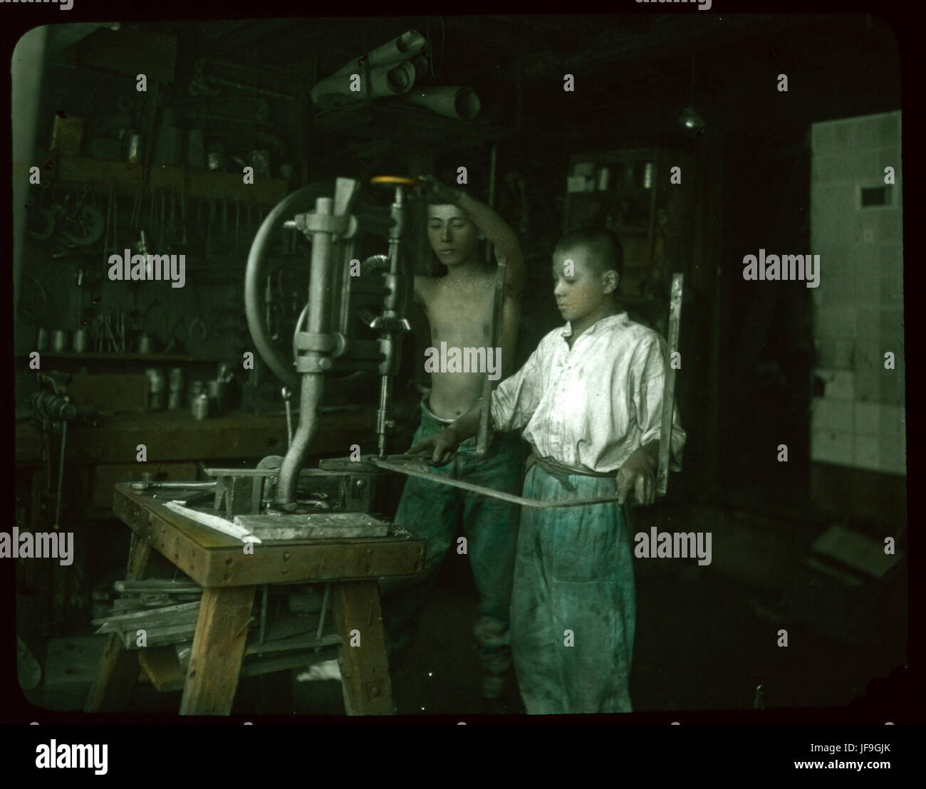 Two boys using drill press 19949925095 o Stock Photo - Alamy